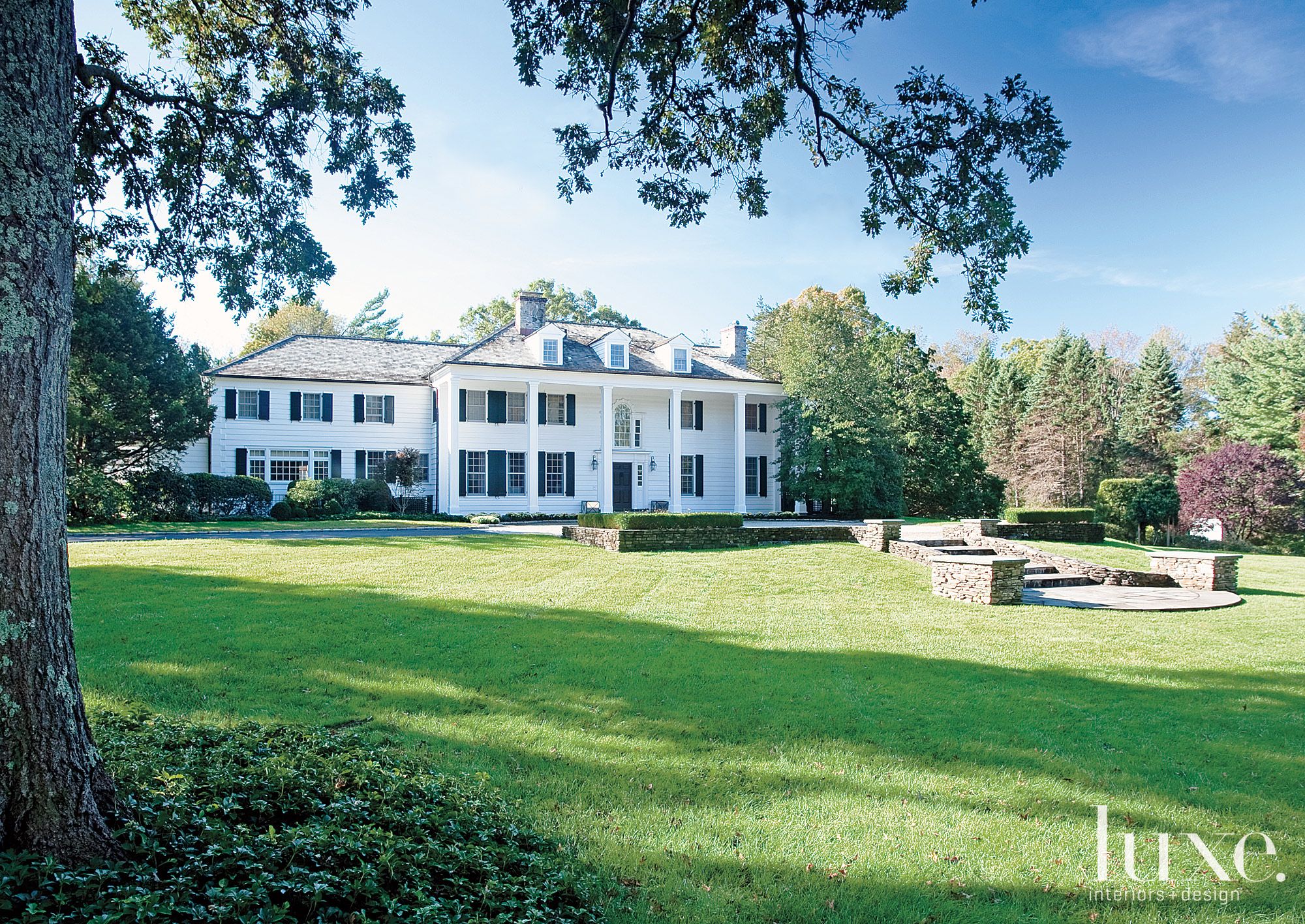 Transitional White Front Exterior with Columns - Luxe Interiors + Design