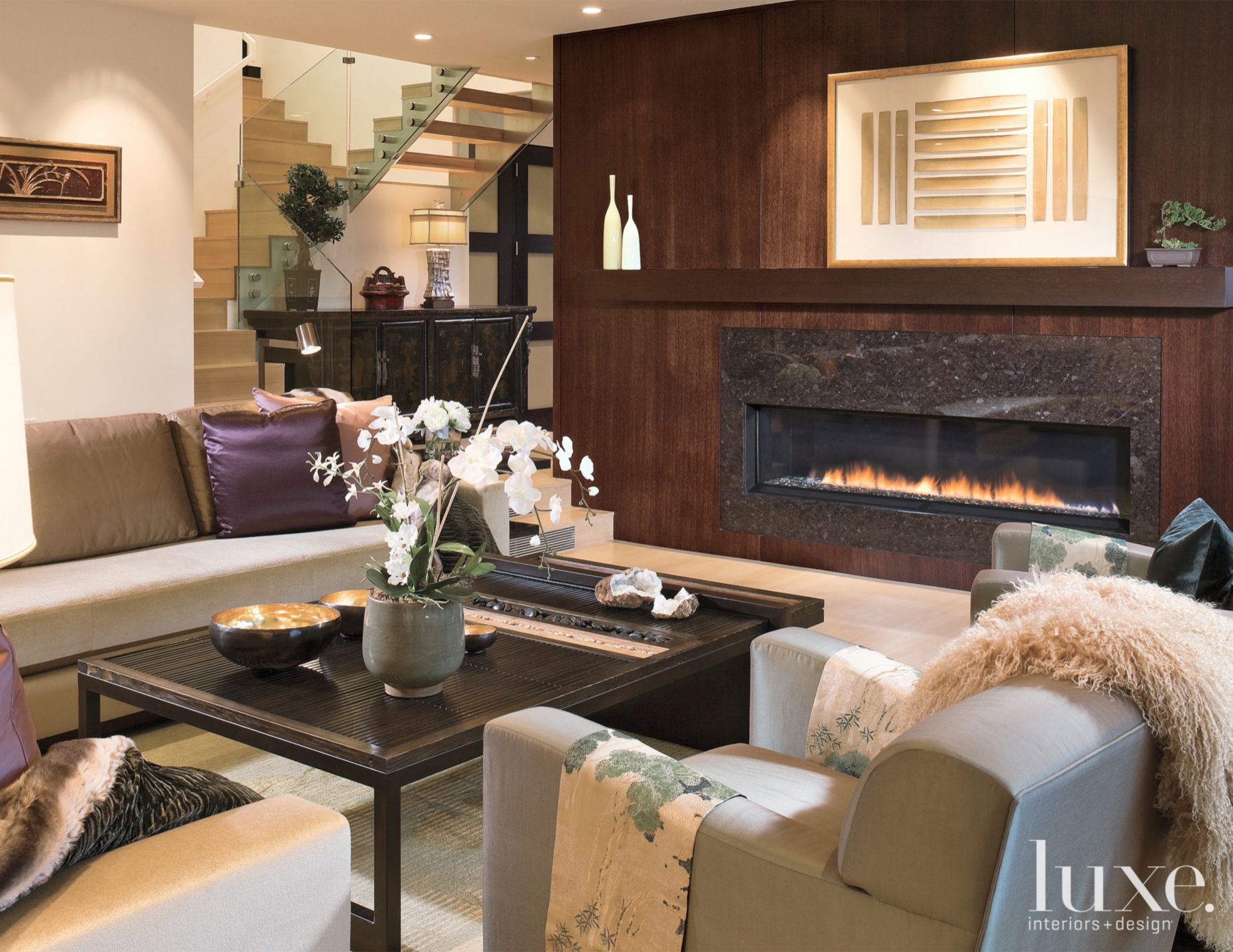 A Living Room With A Large Fireplace - Luxe Interiors + Design
