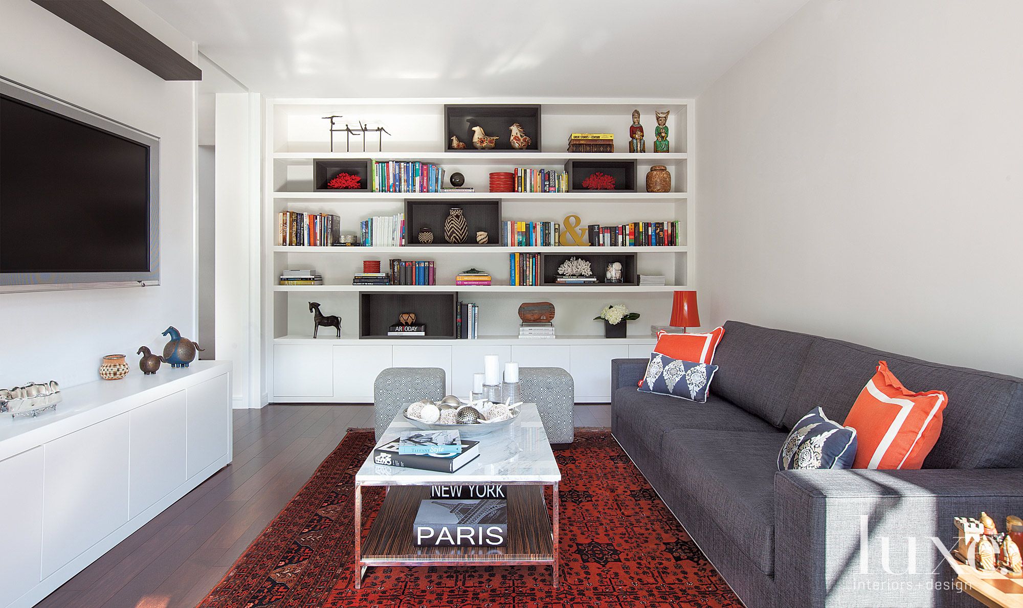 Contemporary Media Room & Library with Red Rug - Luxe Interiors + Design
