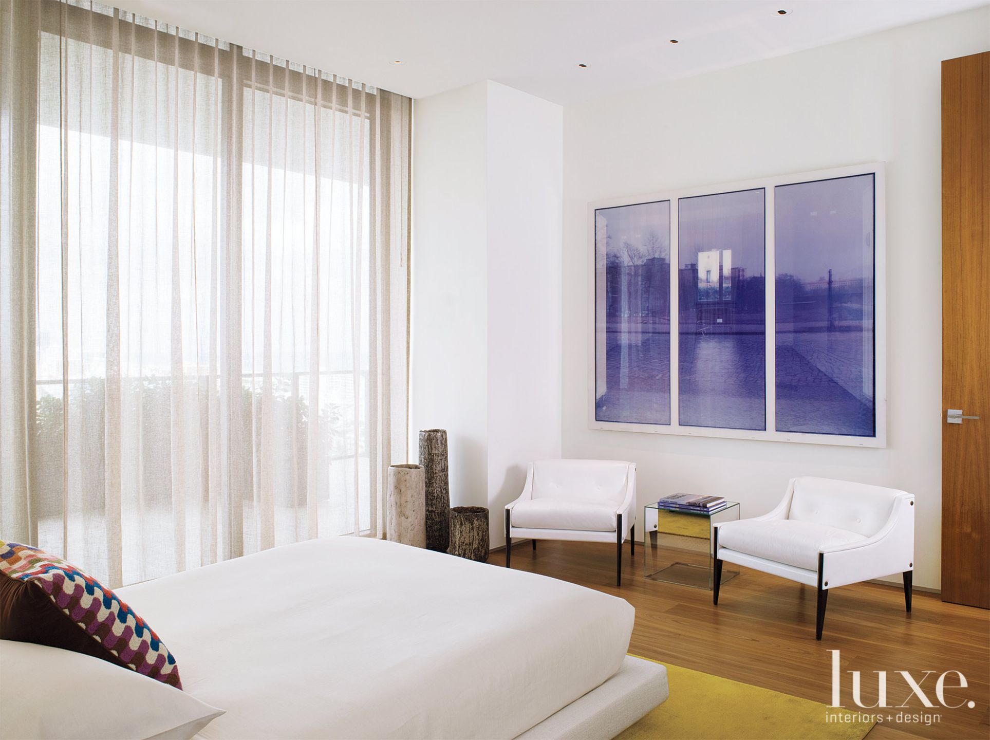 Guest bedroom with owners artwork on wall - Luxe Interiors + Design