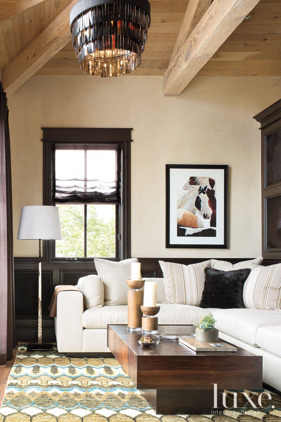 Sitting area with sectional sofa and patterned rug - Luxe Interiors ...