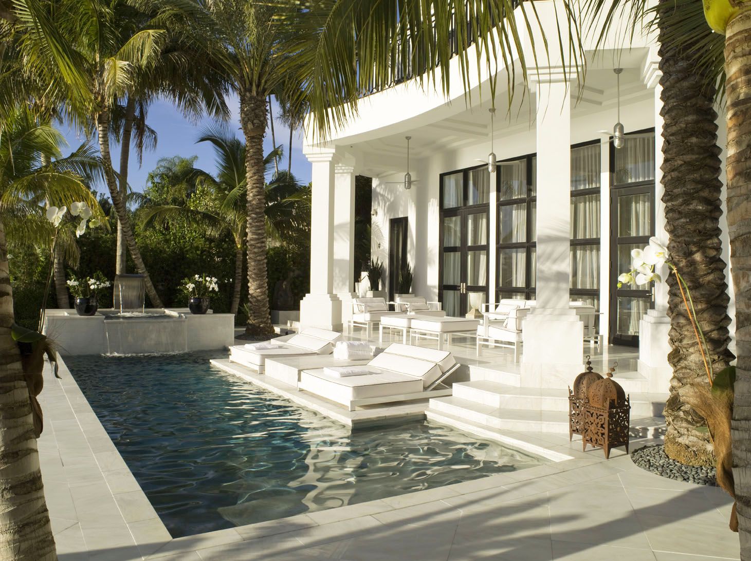 Modern White Poolside Area with Moroccan Antiques - Luxe Interiors + Design