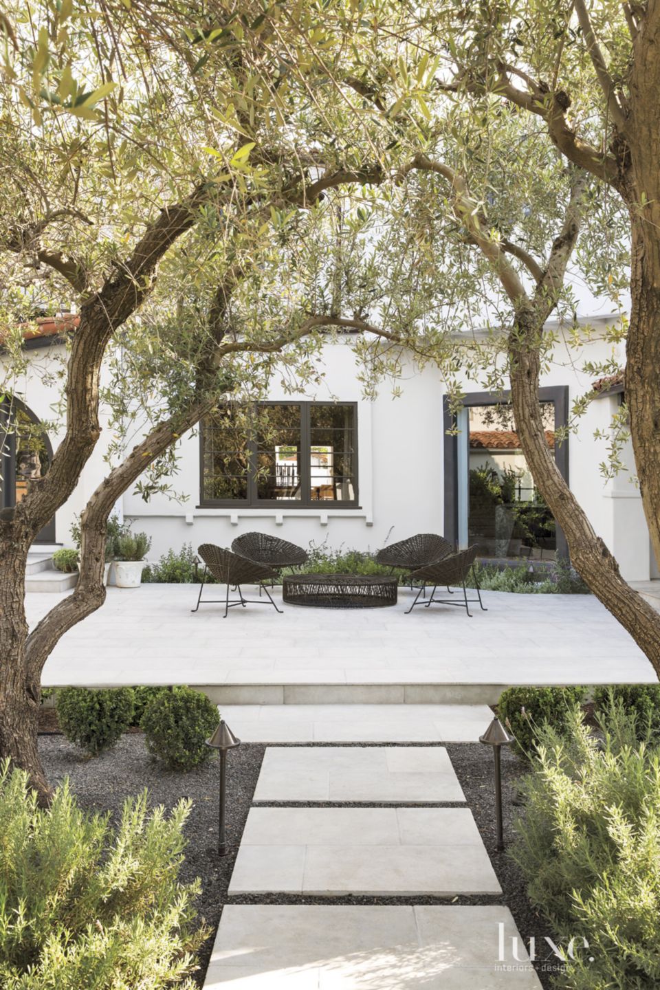 Spanish Colonial Neutral Courtyard with Woven Chairs - Luxe Interiors ...