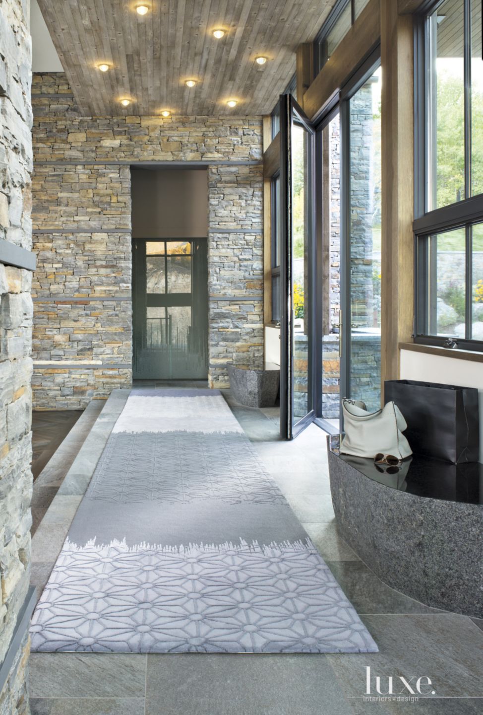 Contemporary Neutral Foyer with Rustic Stone Walls - Luxe Interiors ...