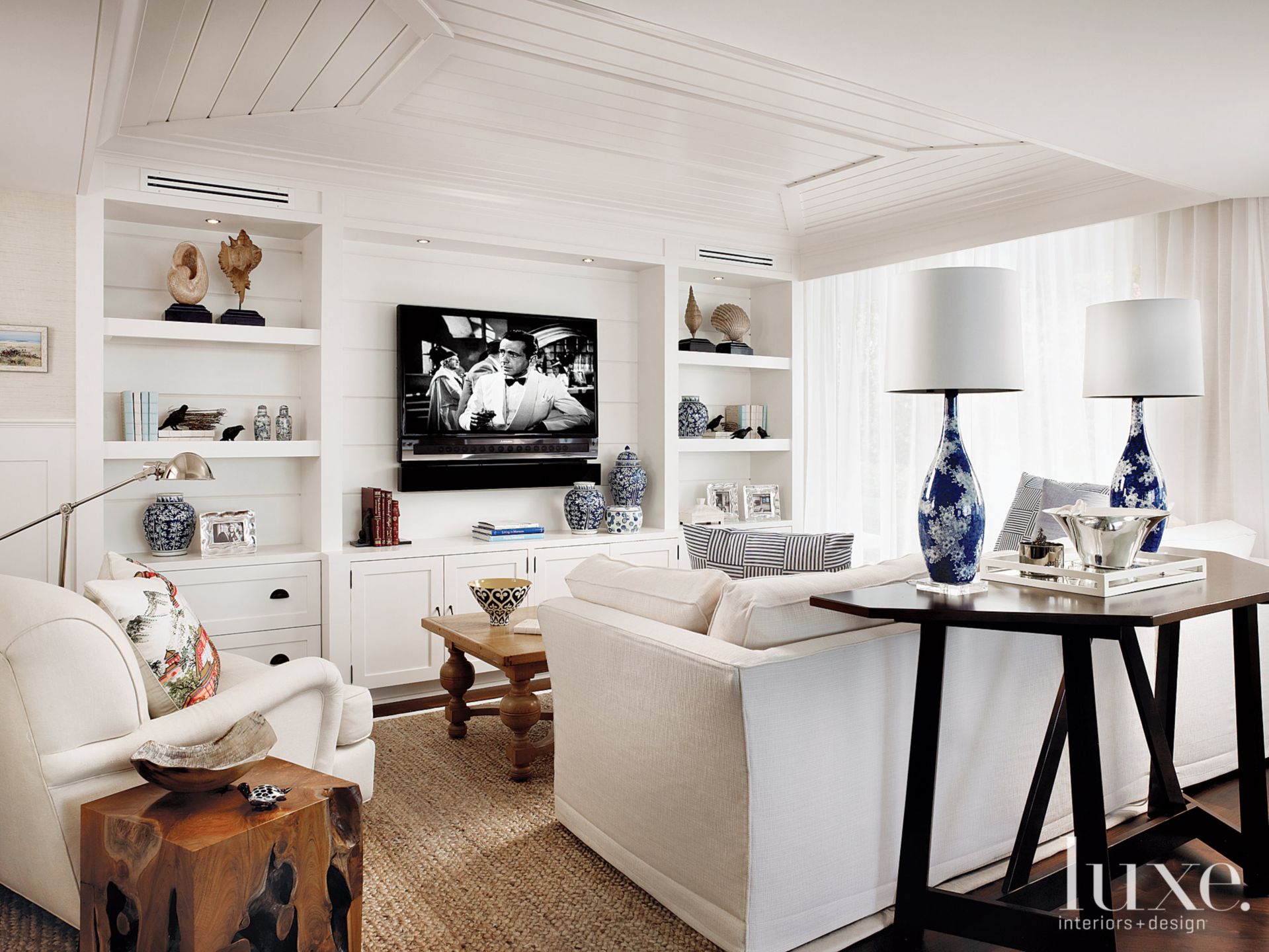 Contemporary White Den with Porcelain Lamps - Luxe Interiors + Design