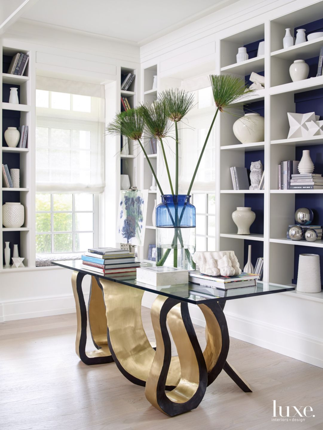 Modern White Library with Artistic Brass Table - Luxe Interiors + Design