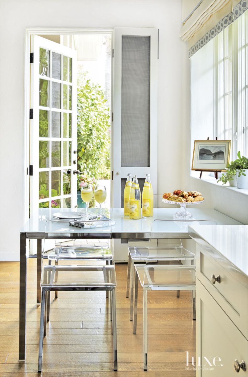 Traditional White Breakfast Area with Acrylic Chairs - Luxe Interiors ...